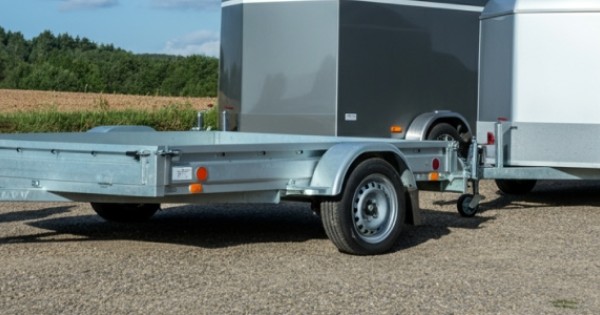 2 small car trailers with a man next to them-600x315h.jpg